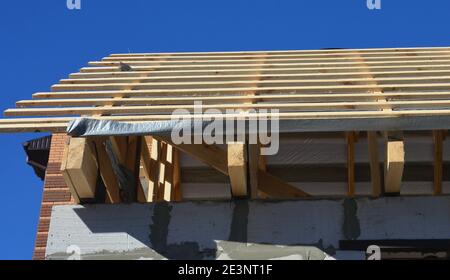 A close-up of an unfinished roofing construction with asphalt roofing ...