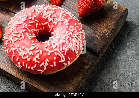 Pink strawberry flavor donuts, on gray background Stock Photo - Alamy