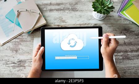 Cloud synchronization progress bar on tablet screen. Data storage and ...