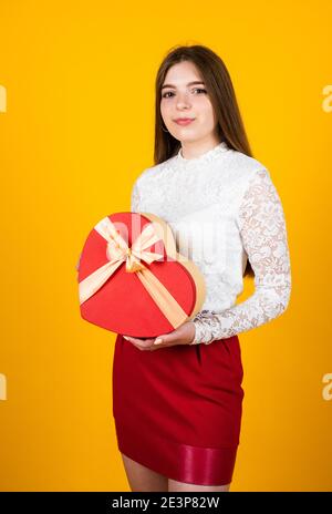 Teenager child with gift box, studio isolated background. Present for ...