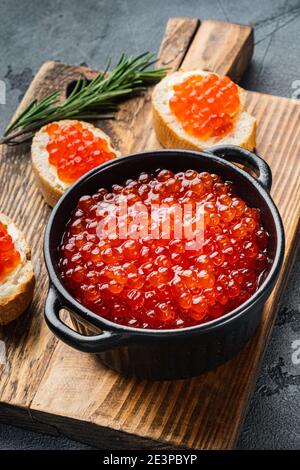 Canape toasts with red caviar, on black background Stock Photo - Alamy