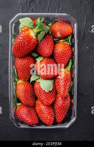 Transparent plastic tray with freshly picked ripe red strawberries ...