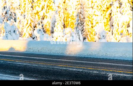 Icy winter road with rugged dark asphalt. Blurred out background Stock ...