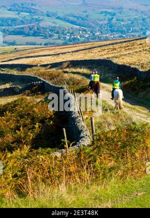 Horse riders on Shatton Lane on Shatton Edge in the Hope Valley area of ...