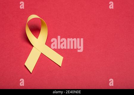 yellow ribbon-childhood cancer awareness symbol on the wooden ...