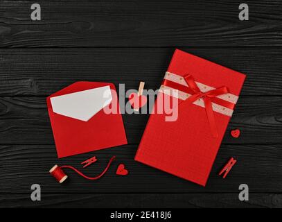 Preparing Valentine gifts, red boxes, hearts, twine, clothespins and ...