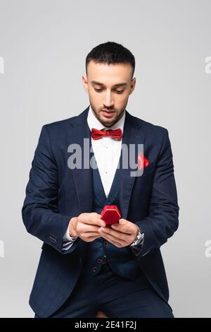 Bearded latino man in a red pullover pointing finger at the camera ...
