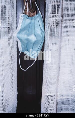 Vertical shot of a surgical mask hanging on a pole in the street Stock ...