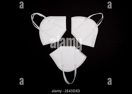 three ffp2 masks on black background. they are best best protection ...