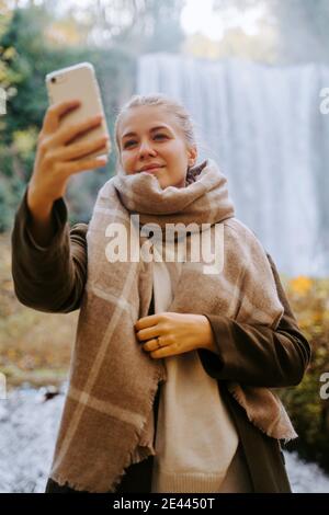 Woman on amazing waterfall background Stock Photo - Alamy