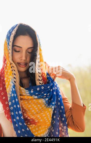 Portrait of young asian woman cover one side of face, looking with one ...