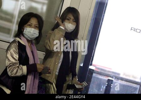 Japanese girls wear masks in precaution against swine influenza when ...