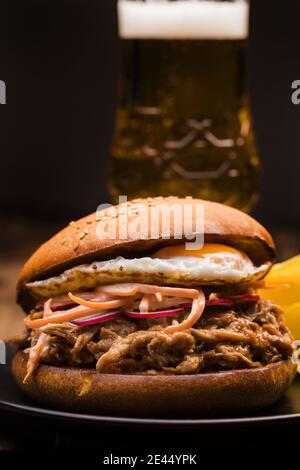 A closeup shot of a tasty hamburger served on a plate with cherry ...