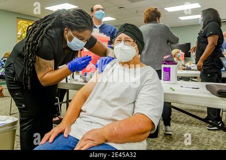 A woman receives a Pfizer-BioNTech coronavirus vaccine at a COVID-19 ...