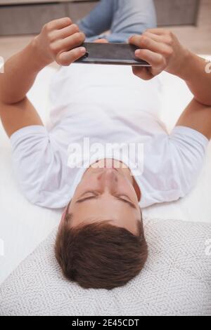 A vertical shot of a a man in a bedsheet standing in a dilapidated ...