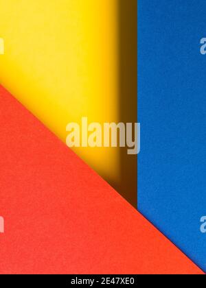 A yellow, blue, and red paper background, the colors of the flags of ...
