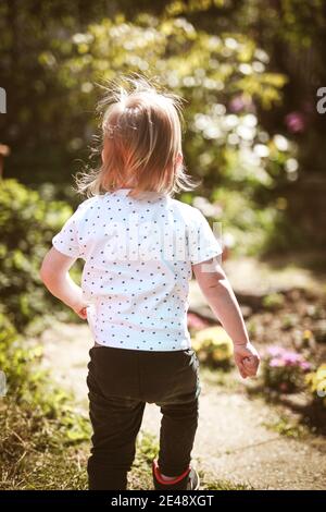 Little Girl From Behind Running On Bridge to Beach with Red Bucket ...
