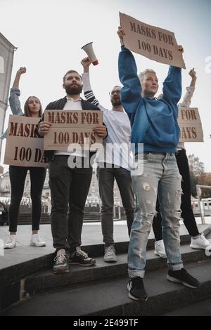 Covid and healthcare concept. Angry man in face mask pointing fingers ...