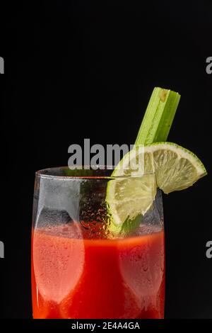 Glass of refreshing cocktail with celery, lime and ginger decorated ...