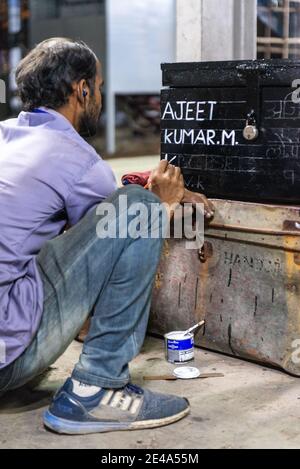Railway station staff writing name of newly joined loco pilot on a line ...