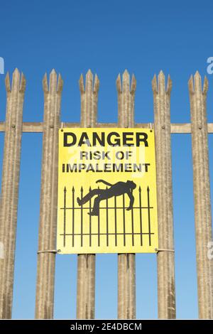 Impalement danger and risk sign on fence for security and protection ...