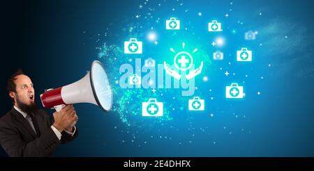 Young person with megaphone and healthcare icon Stock Photo - Alamy