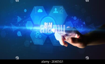 Hand touching BIM inscription, new technology concept Stock Photo - Alamy