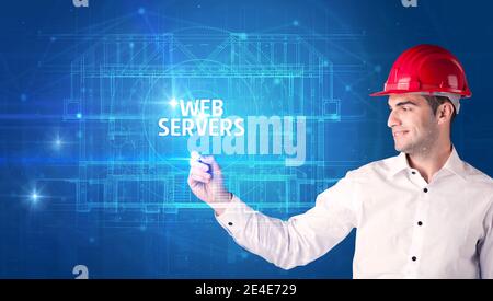 Handsome architect with helmet drawing WEB SERVERS inscription, new ...