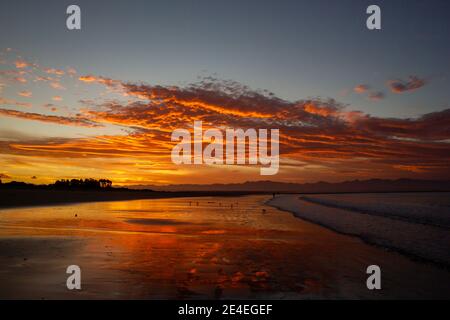 Beach in Nelson during a breathtaking sunset on Tahunanui Beach at ...