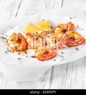 Cooked shrimps with thyme and lemon wedges on serving plate Stock Photo ...
