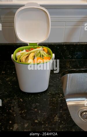 Vegetable and fruit waste collected into a bucket for home composting ...