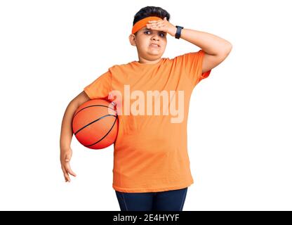 Sad disappointed boy with basketball ball in a physical education ...