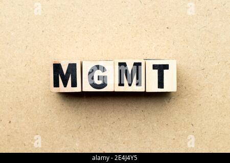 Wood letter in word mgmt (abbreviation of Management) on green grass ...