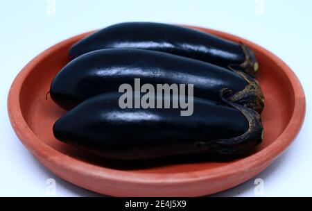 Nasubi or Japanese Eggplant on pottery plate, on white background Stock ...