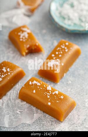 Homemade caramel. Brown caramel candies. Creamy sweets with peanuts. On ...