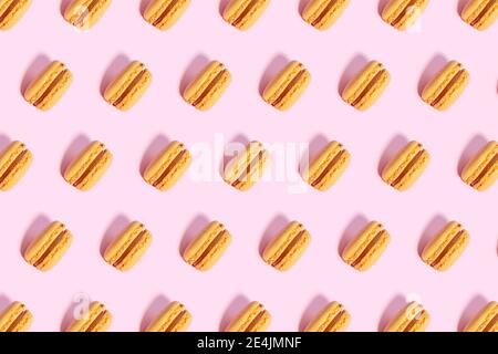 seamless pattern of pink macaroon cookies on red background Stock Photo ...