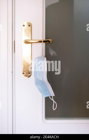 A face mask hanging on a golden stand Stock Photo - Alamy