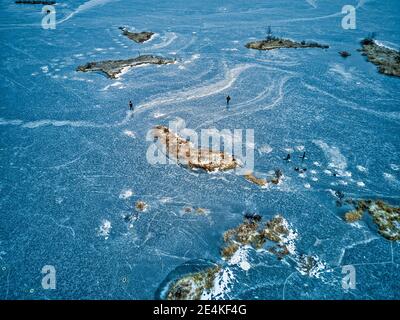 Aerial of fisherman walking on lake Tengiz, Korgalzhyn Nature Reserve ...