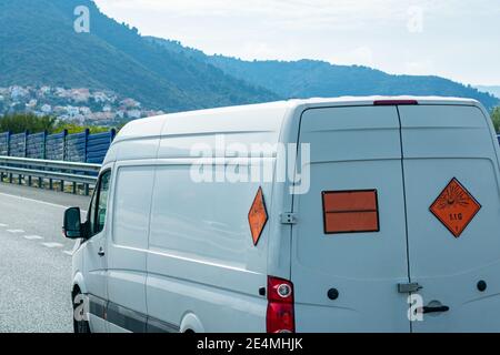 Van transporting explosives, with orange panel and danger labels for ...
