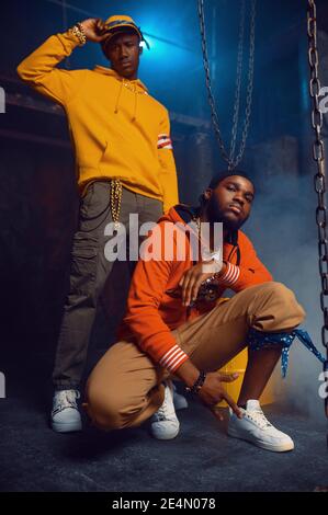 Two stylish rappers poses in studio Stock Photo - Alamy