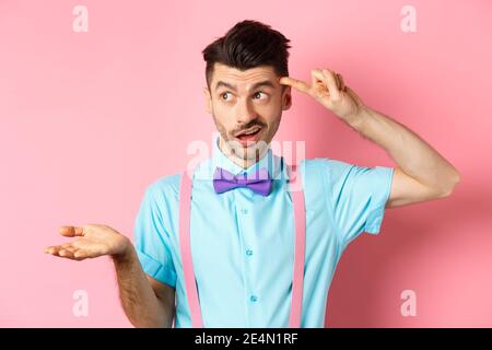 Annoyed and skeptical guy complain on something stupid, pointing finger ...