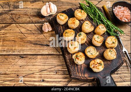 BBQ Seared scallops with butter sauce on a wooden board. wooden ...