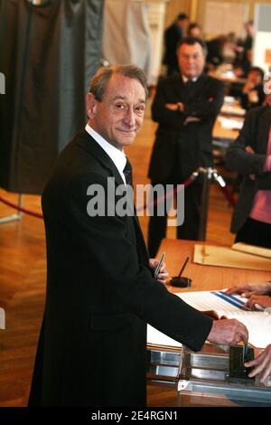 Mayor of Paris Bertrand Delanoe cast his ballot at a polling station ...
