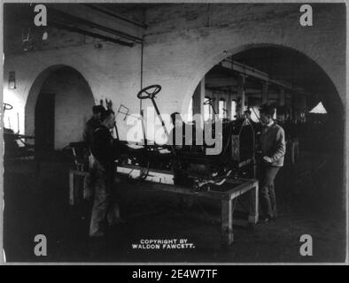 Men assembling auto in a plant Stock Photo - Alamy