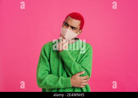 Brooding african american guy in Santa Claus hat using cellphone ...
