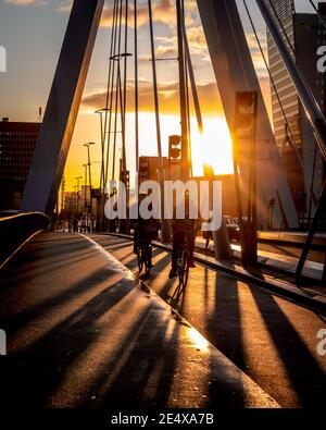 ROTTERDAM, NETHERLANDS - Nov 30, 2019: Someone jogging during sunrise ...