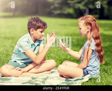 happy kids playing rock-paper-scissors game Stock Photo - Alamy