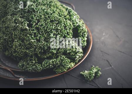 Green kale leaves in metal basket on grey background Stock Photo - Alamy