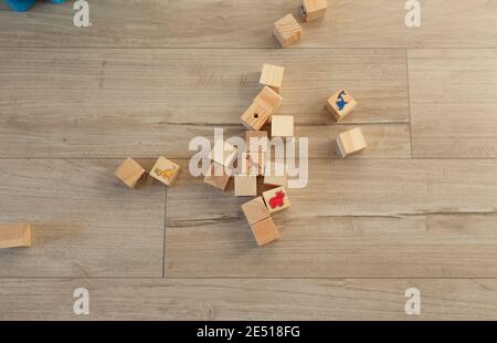Scattered on wooden floor children's toys, plastic blocks, construction ...