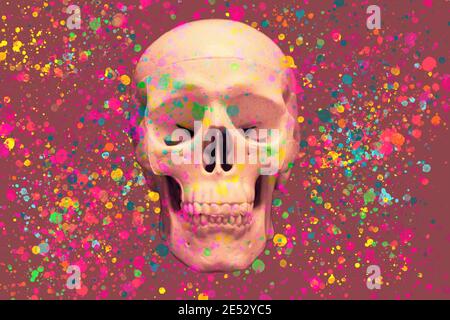 Small model skull with paint splater background Stock Photo - Alamy